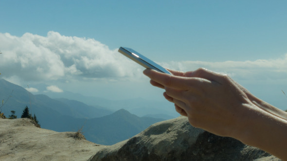 Chatting On Mobile Phone At Mountain by Nuwanhaha | VideoHive
