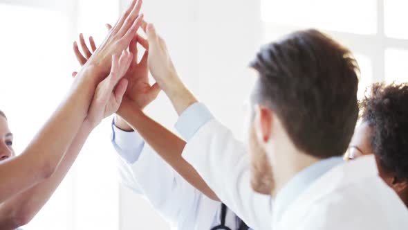 Group Of Happy Doctors Making High Five At Clinic 3 by dolgachov ...