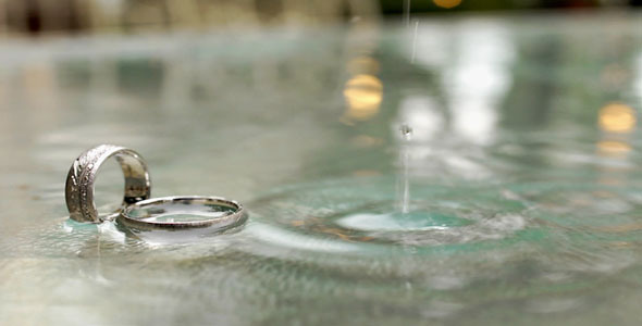 Rain Drops Over Wedding Rings by cosmindumitrache | VideoHive