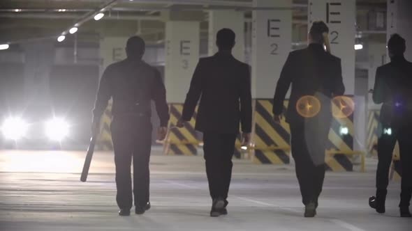 Four Confident Mafia Men in Black Suits Holding Baseball Bats and ...